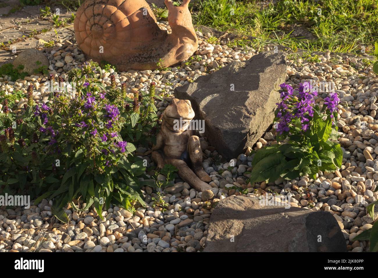 Decorated colorful flowerbed with stones as a decorative elements ...