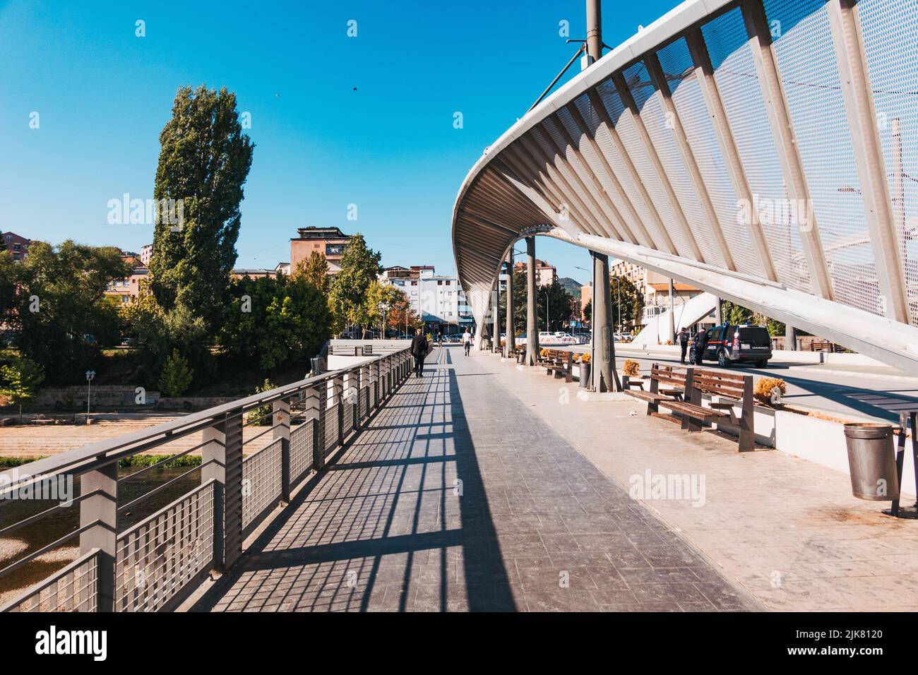 a sidewalk on the New Bridge in Mitrovica, Kosovo. The bridge connects ...