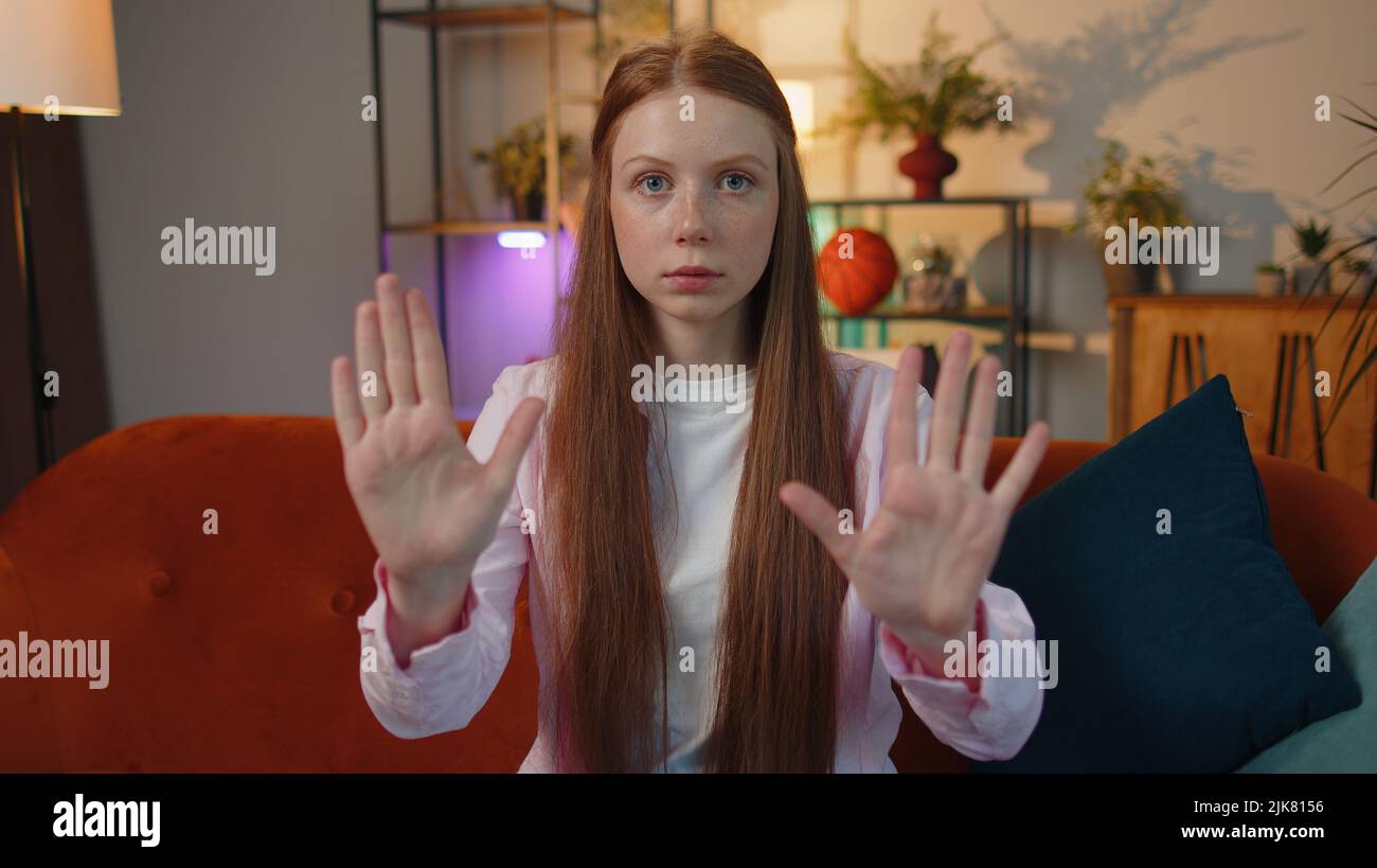 Stop gesture. Angry redhead child girl say No hold palm folded crossed ...