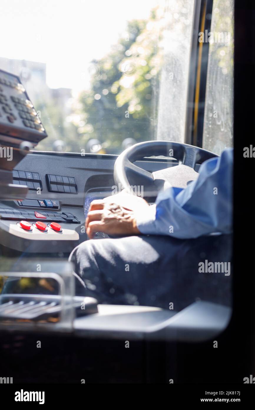 A London bus drivers cockpit driving controls and switches seen through ...