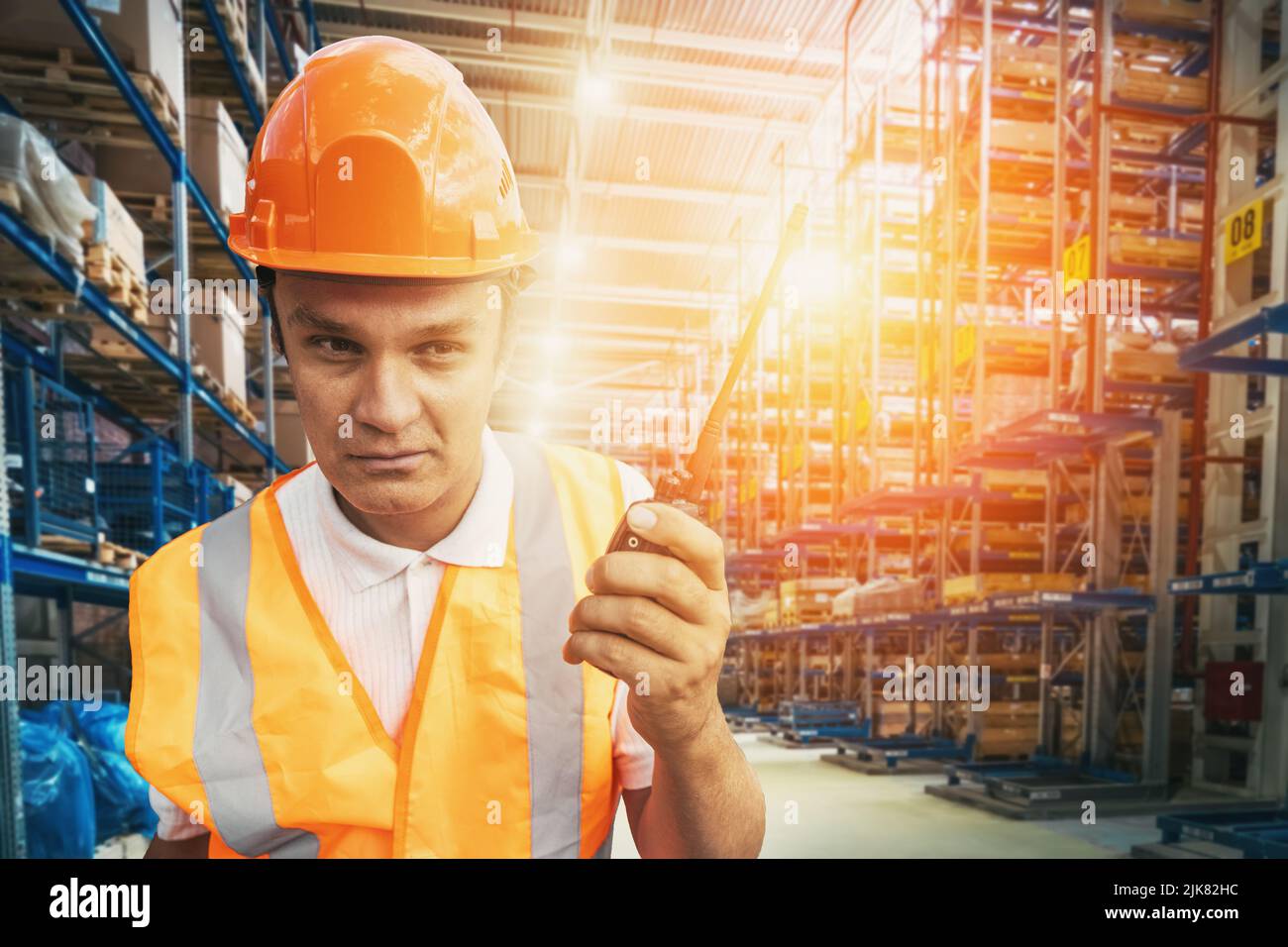 Logistic warehouse worker in helmet. Distribution warehouse with many ...