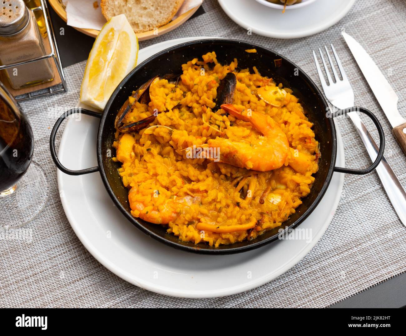 Traditional dish of Spanish cuisine is paella with seafood Stock Photo ...