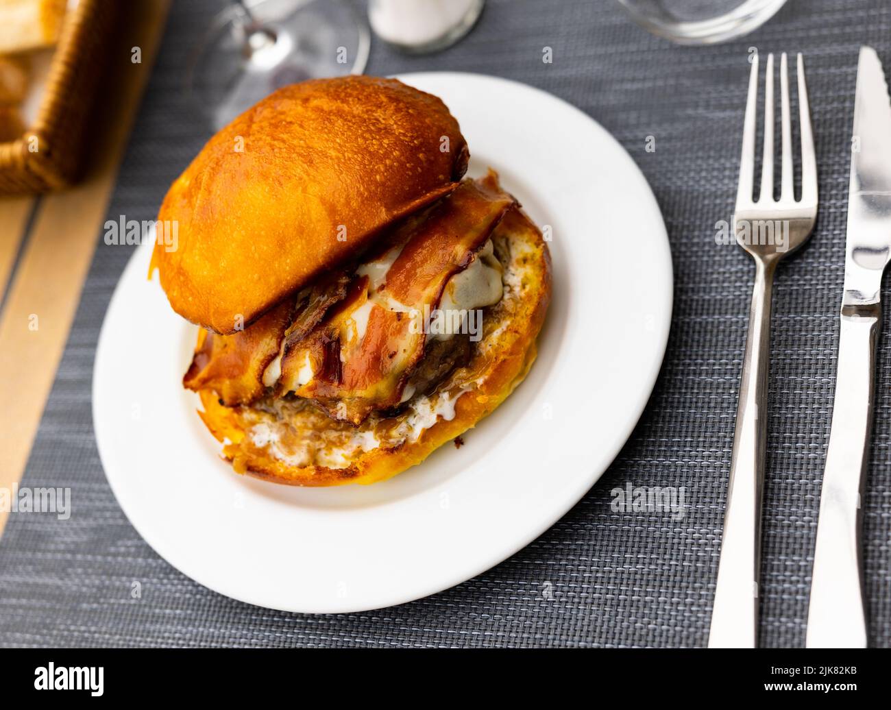 Cheeseburger with beef patty and fried bacon slices in bun Stock Photo ...