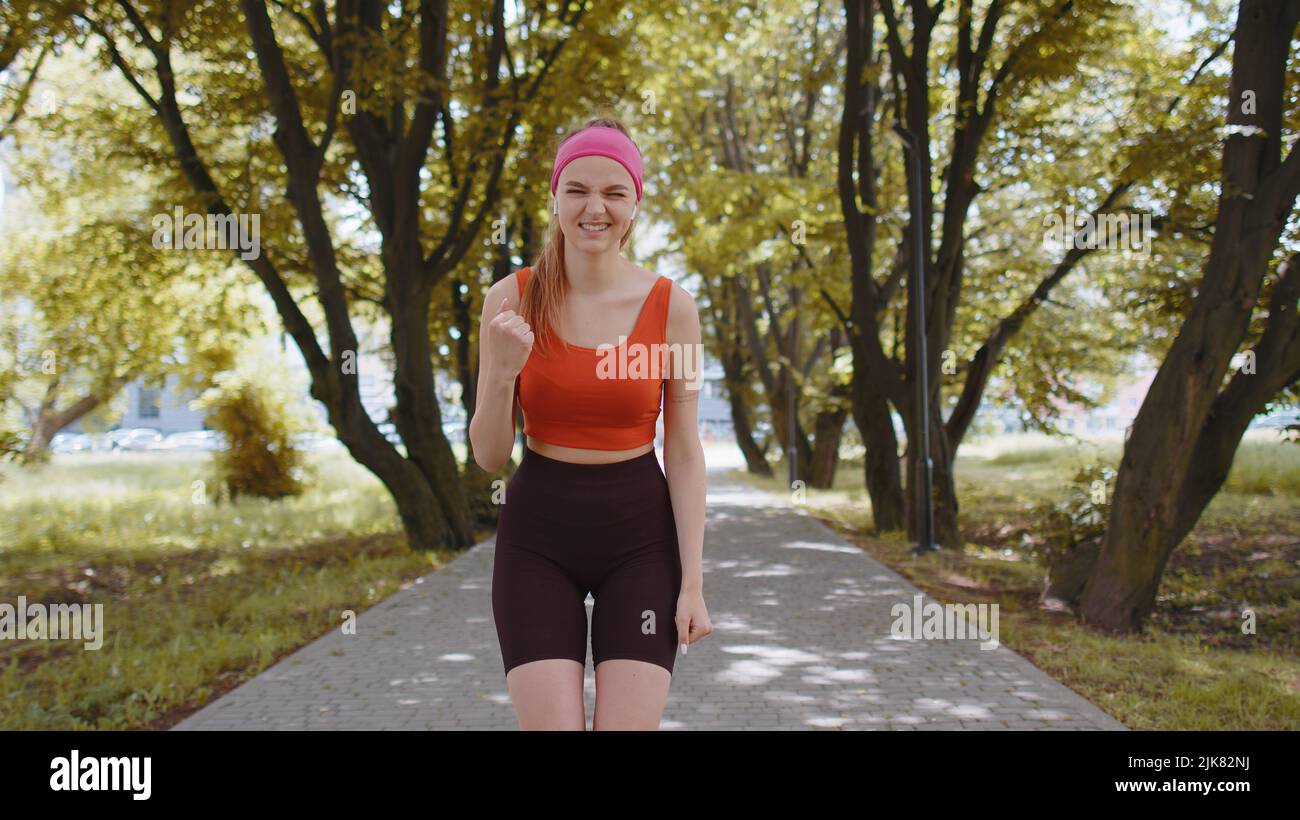 Athletic fit runner girl celebrate success win scream rejoices triumph ...