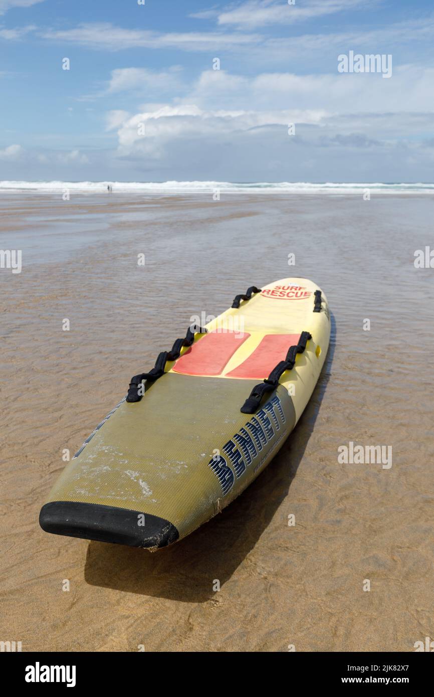 RNLI Lifeguard surf rescue board on a sandy beach on a bright summer ...