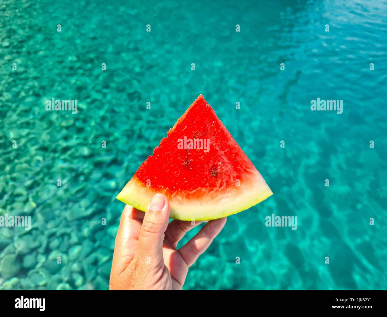 Bright red watermelon on blue sea background Stock Photo - Alamy