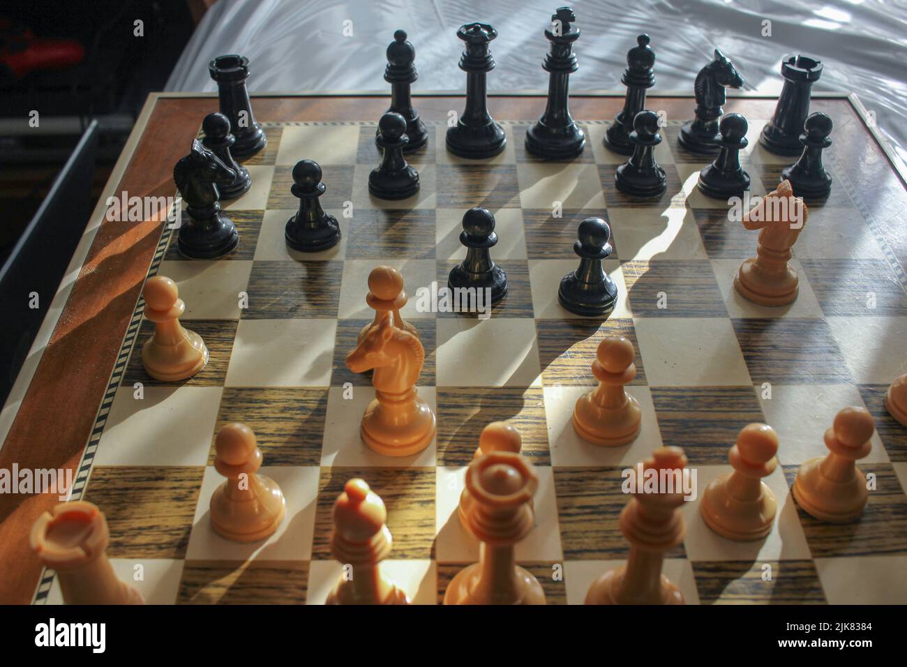 sunset light and shades reach the chess board Stock Photo - Alamy