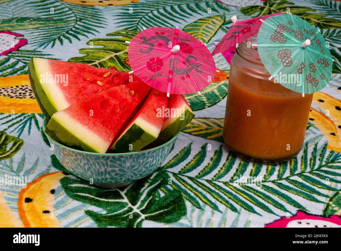 Freshly cut watermelon with a small umbrella, a glass of gazpacho on a ...