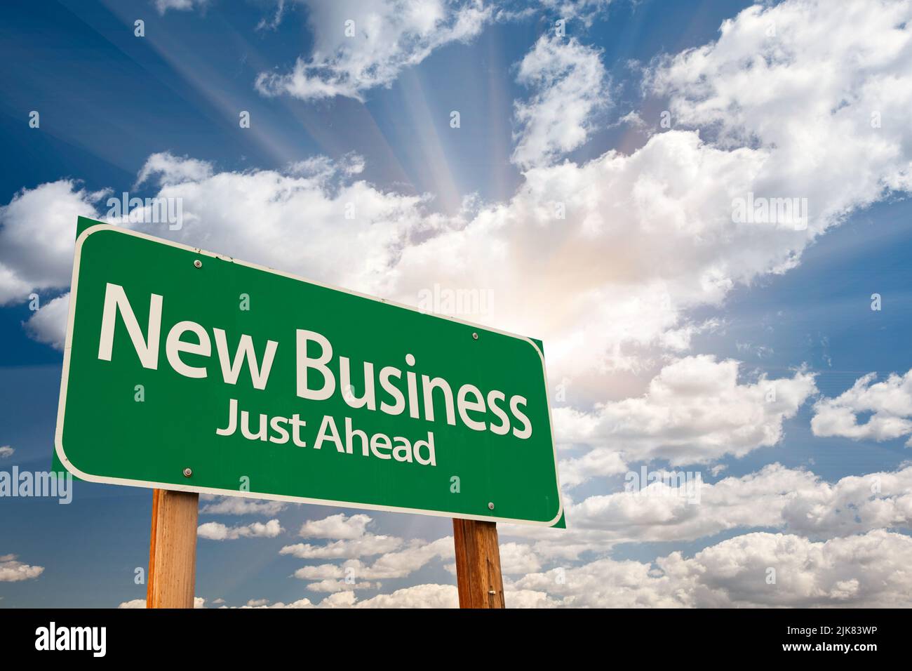 New Business Green Road Sign Over Sunny Dramatic Clouds and Sky Stock ...