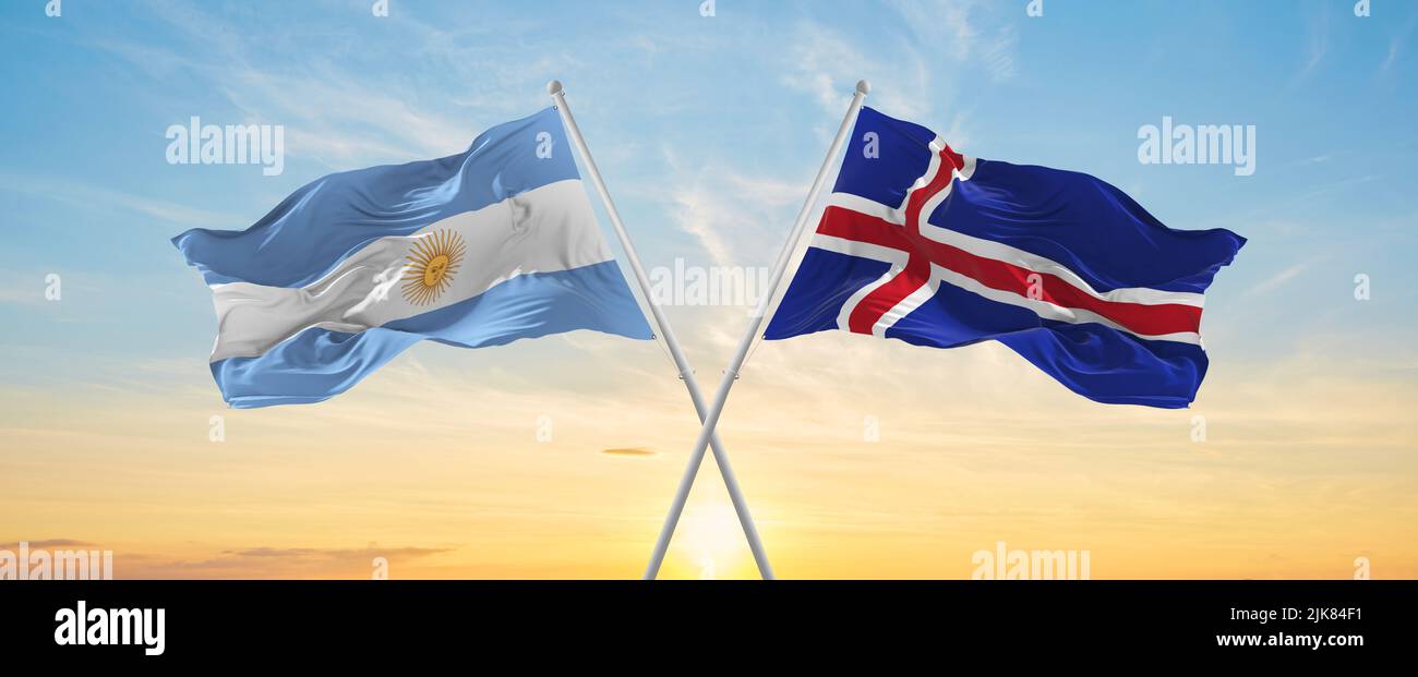 crossed national flags of Argentine and Iceland flag waving in wind at ...