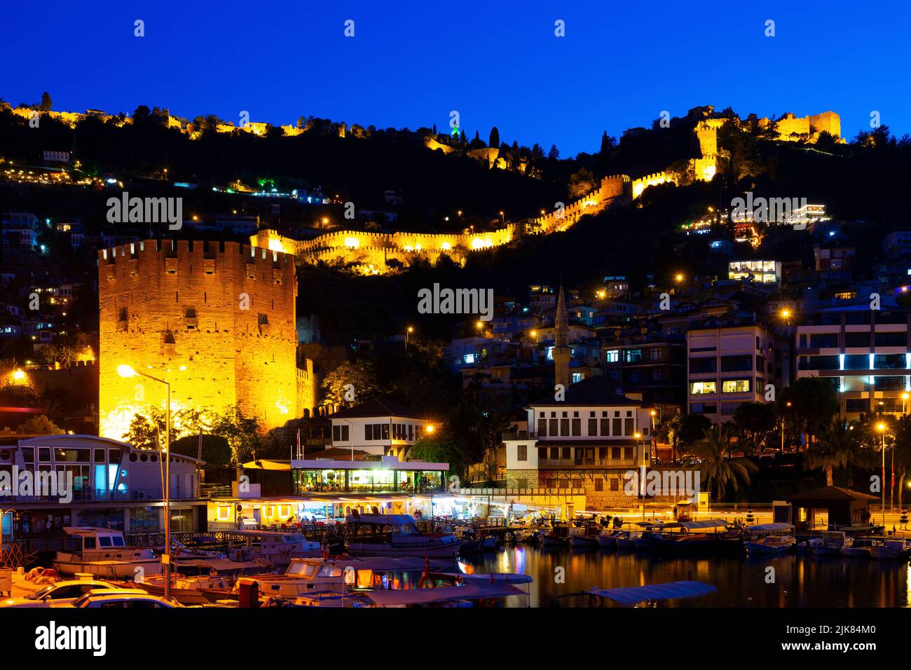 Night view of Alanya cityscape from harbor pier overlooking Red Tower ...