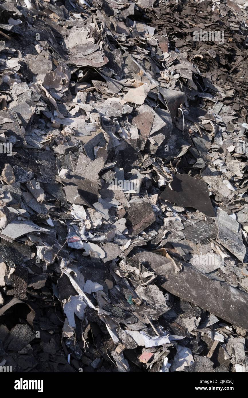 Pile of discarded asphalt roofing shingles in recycling yard Stock ...