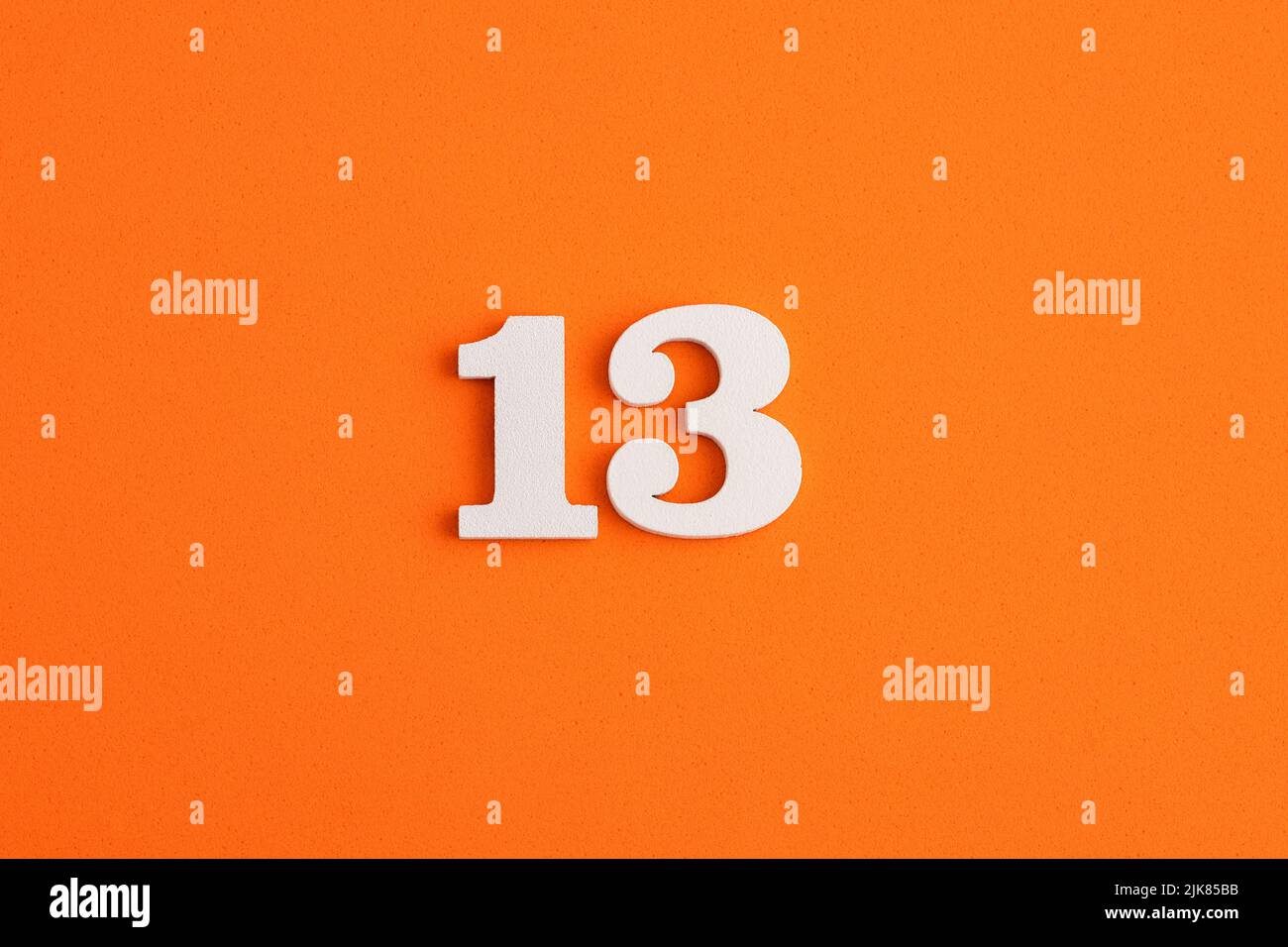 Number 13 - On orange foam rubber background Stock Photo - Alamy