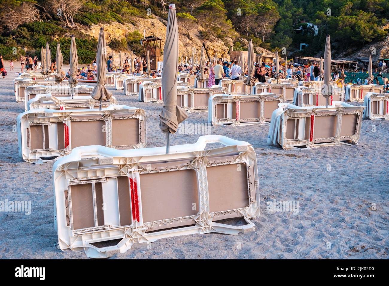 Ibiza, spain - july 25, 2022: Plastic sunbeds on a beach, folded at ...
