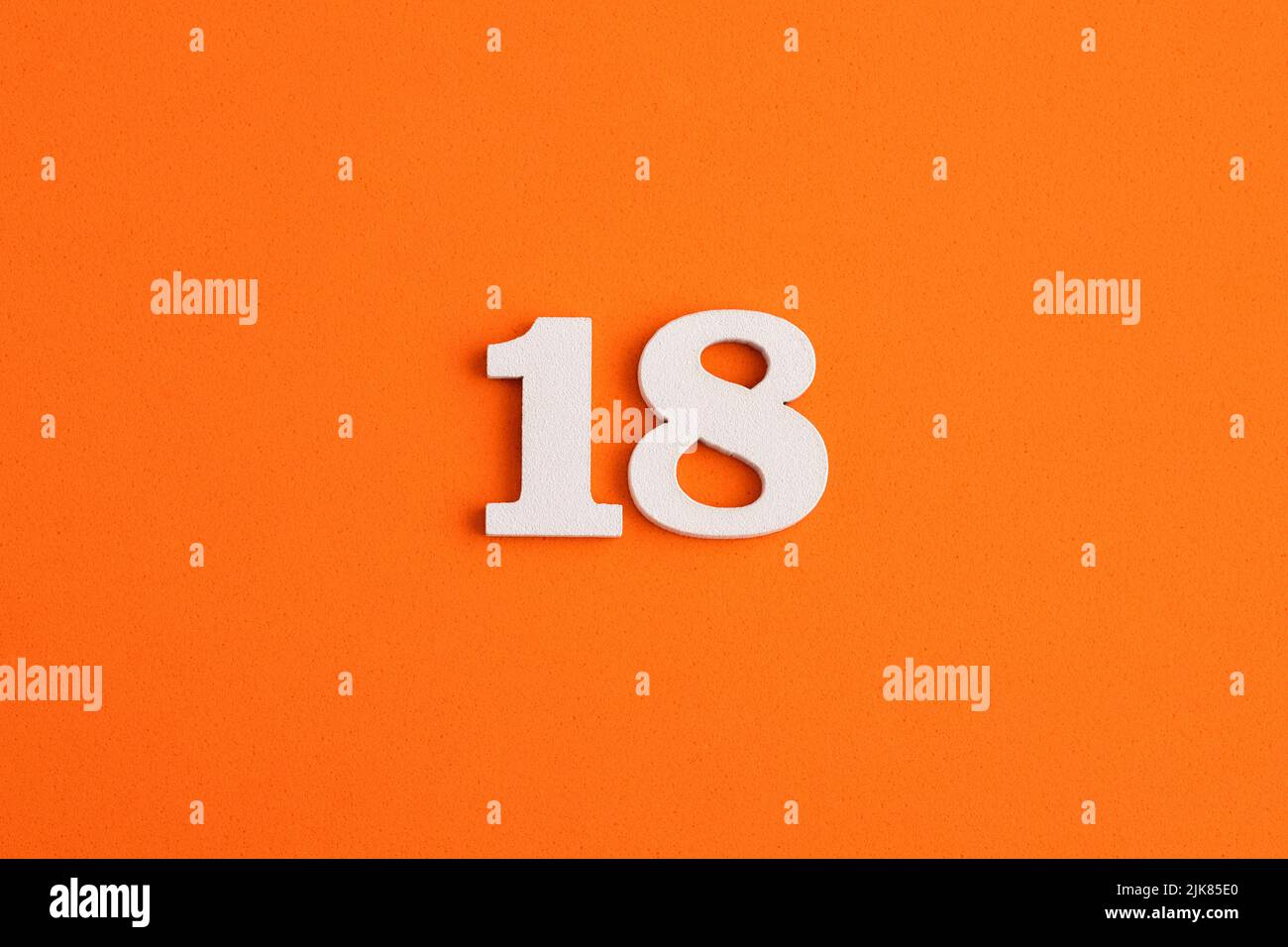 White wooden number 18 on eva rubber orange background Stock Photo - Alamy
