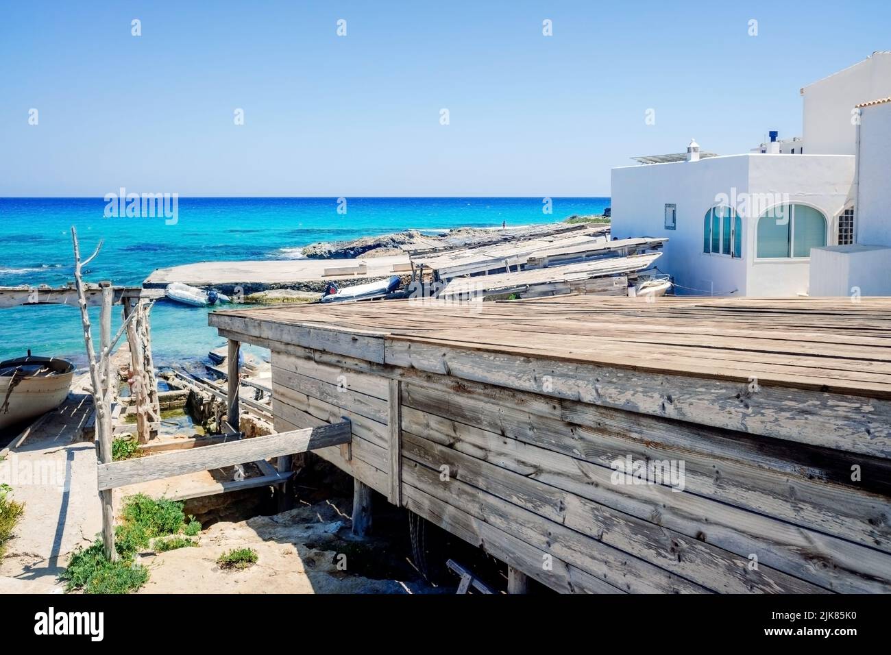 Traditional rustic pier with wooden boards in a cove in Formentera ...