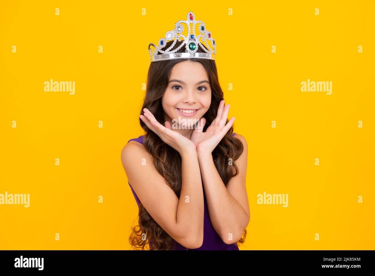 Little queen wearing golden crown. Teenage girl princess holding crown ...