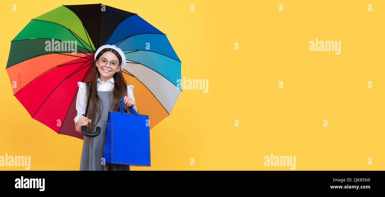 happy teen girl under colorful umbrella in autumn season hold shopping ...