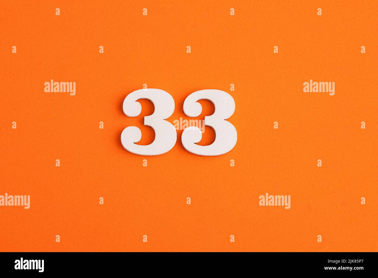 Number 33 - On orange foam rubber background Stock Photo - Alamy