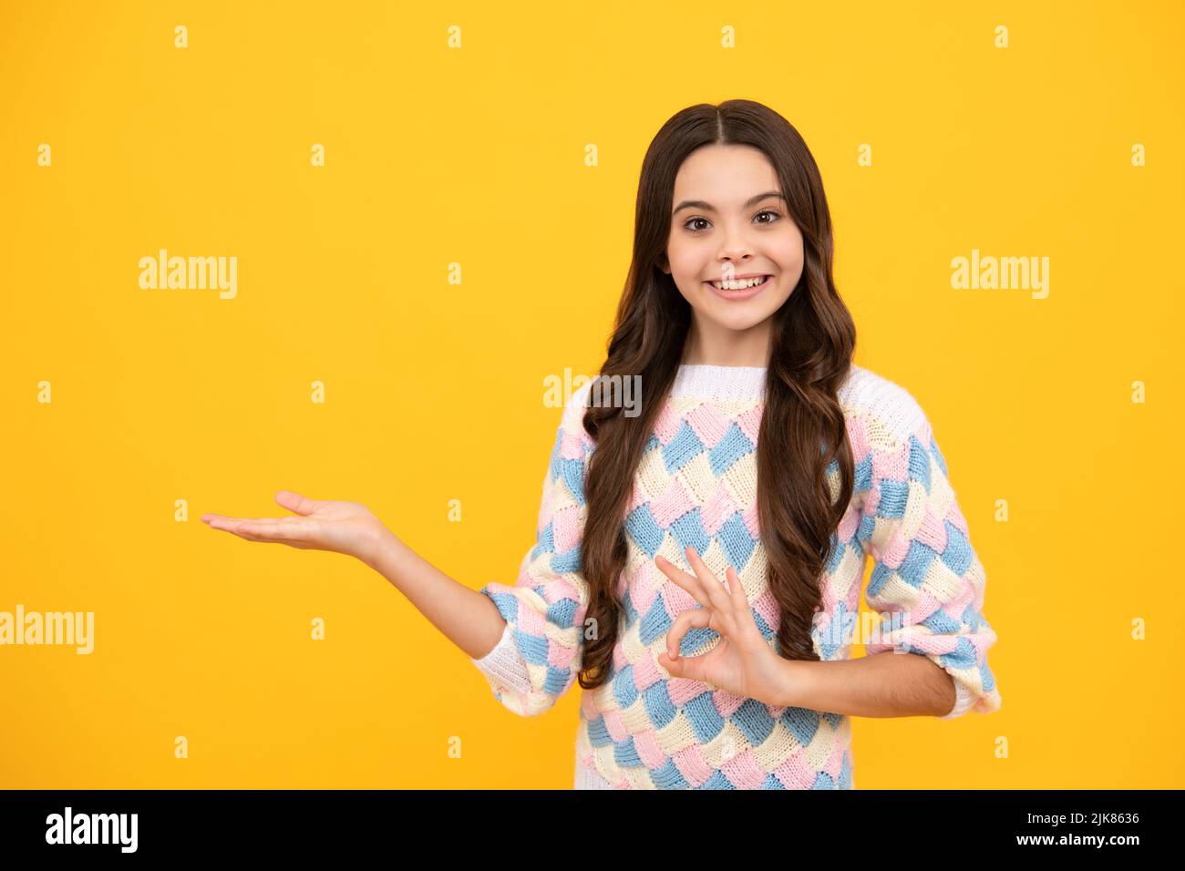Impressed teenage girl showing recommendation copyspace. Child teenager ...