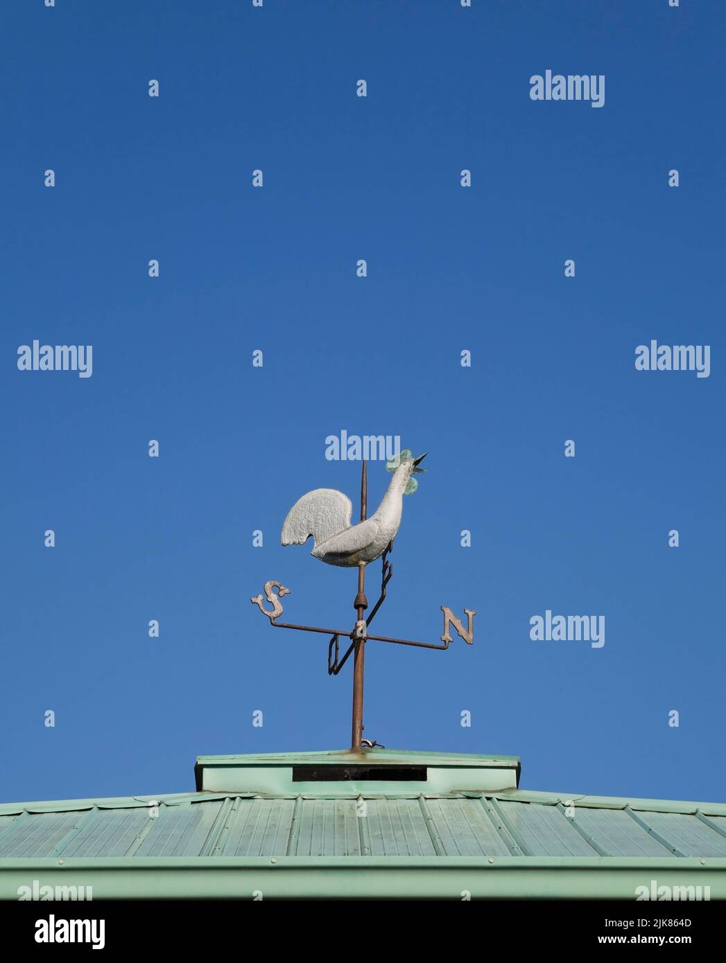 Weathervane in the form of a rooster mounted on top of a building Stock ...
