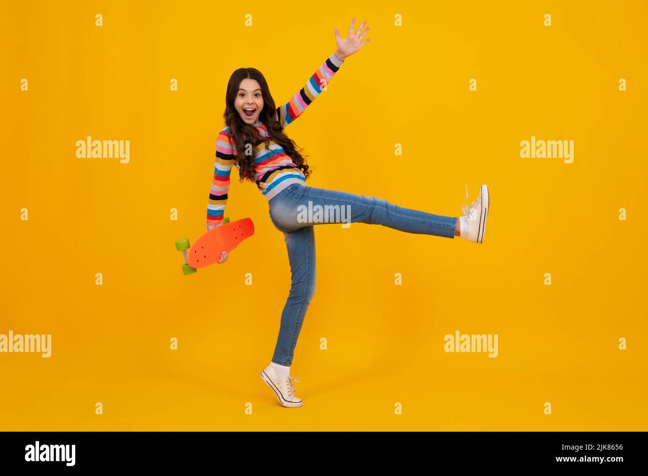 Jump and run. Amazed teenager. Teen school girl with skateboard on ...