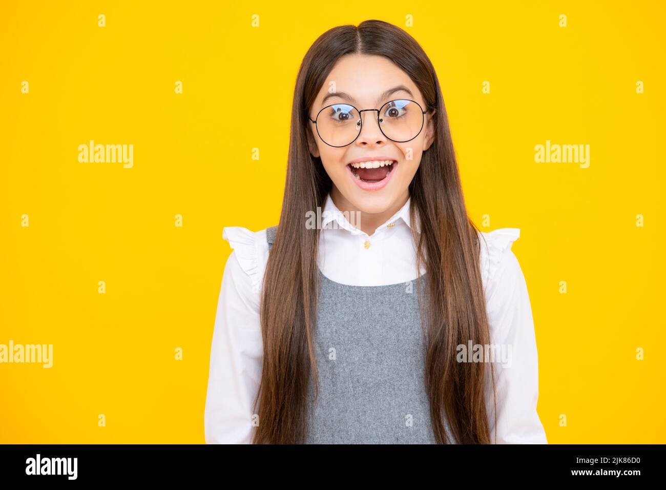 Excited face. Amazed child with open mouth on yellow background ...