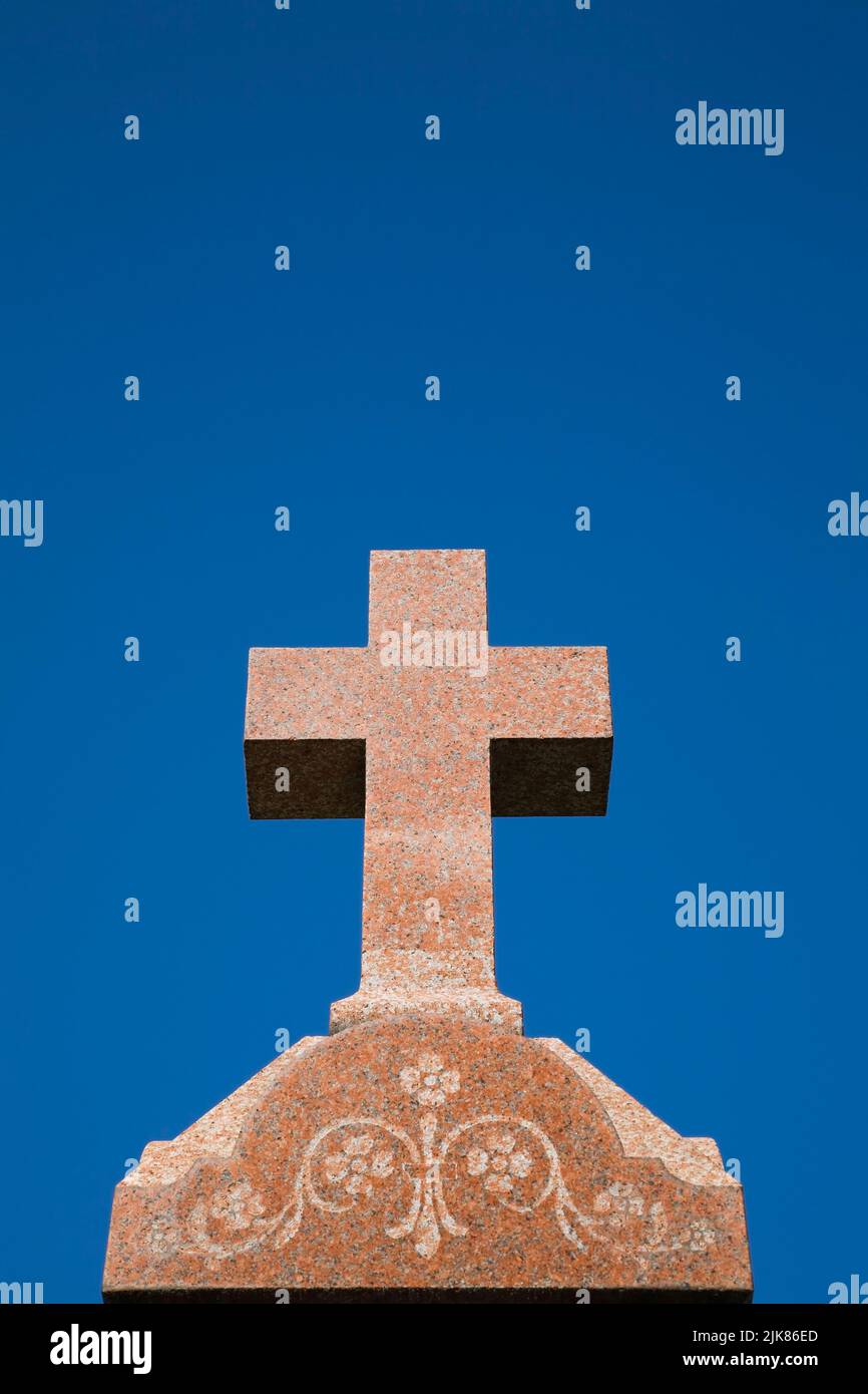 Close-up of granite cross atop a headstone in cemetery Stock Photo - Alamy
