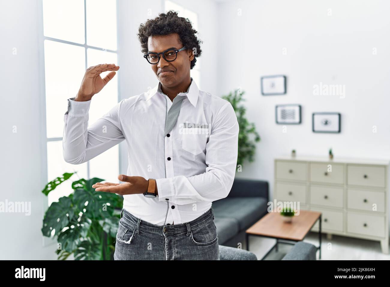 African psychologist man at consultation office gesturing with hands ...