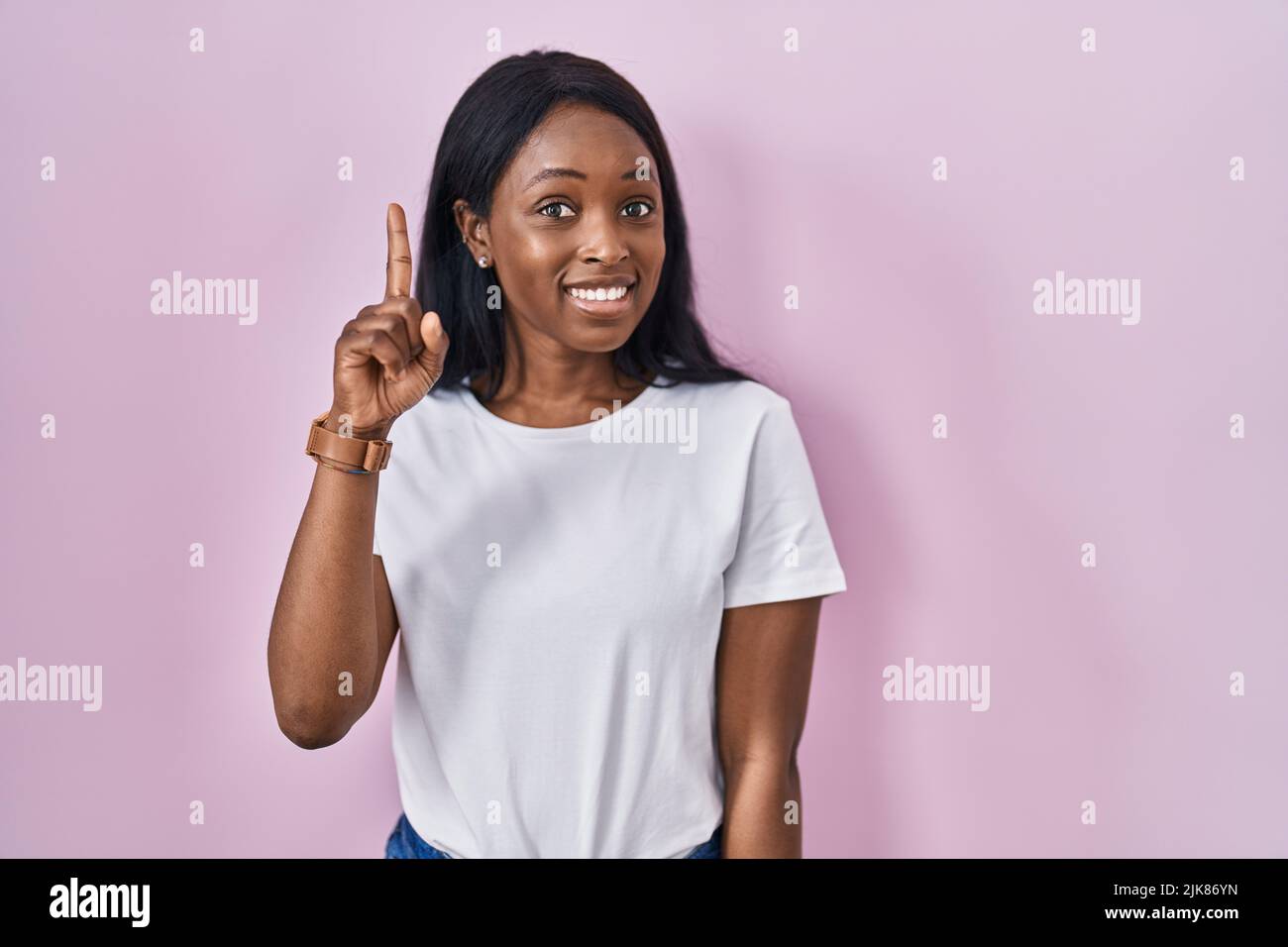 African Young Woman Wearing Casual White T Shirt Pointing Finger Up