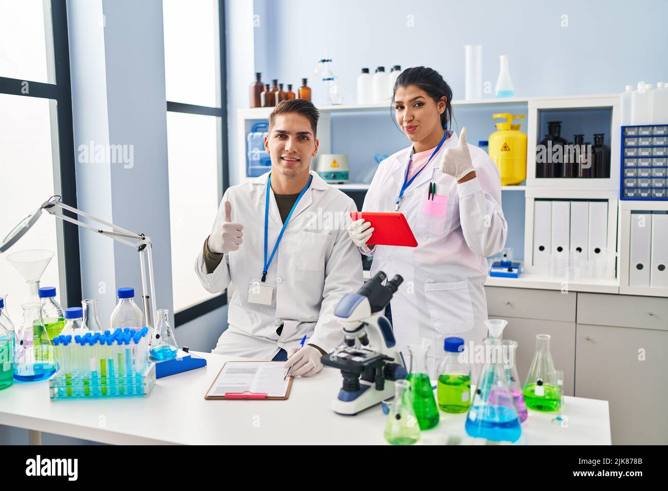 Young doctors working at scientist laboratory smiling happy and ...