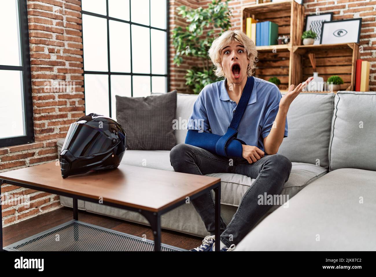 Young man wearing arm on sling for motorcycle accident celebrating ...