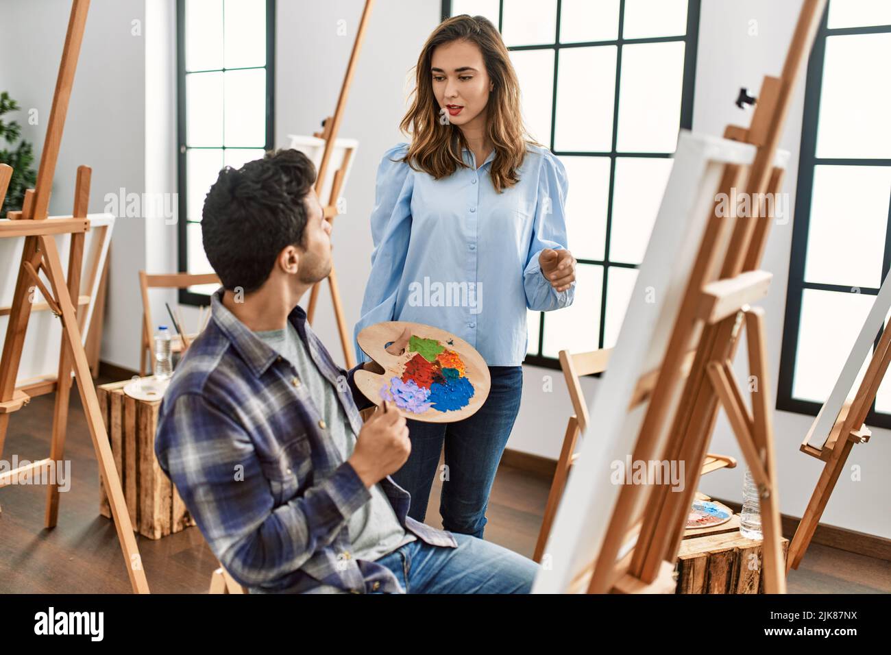 Paint teacher teaching to student at art school Stock Photo - Alamy