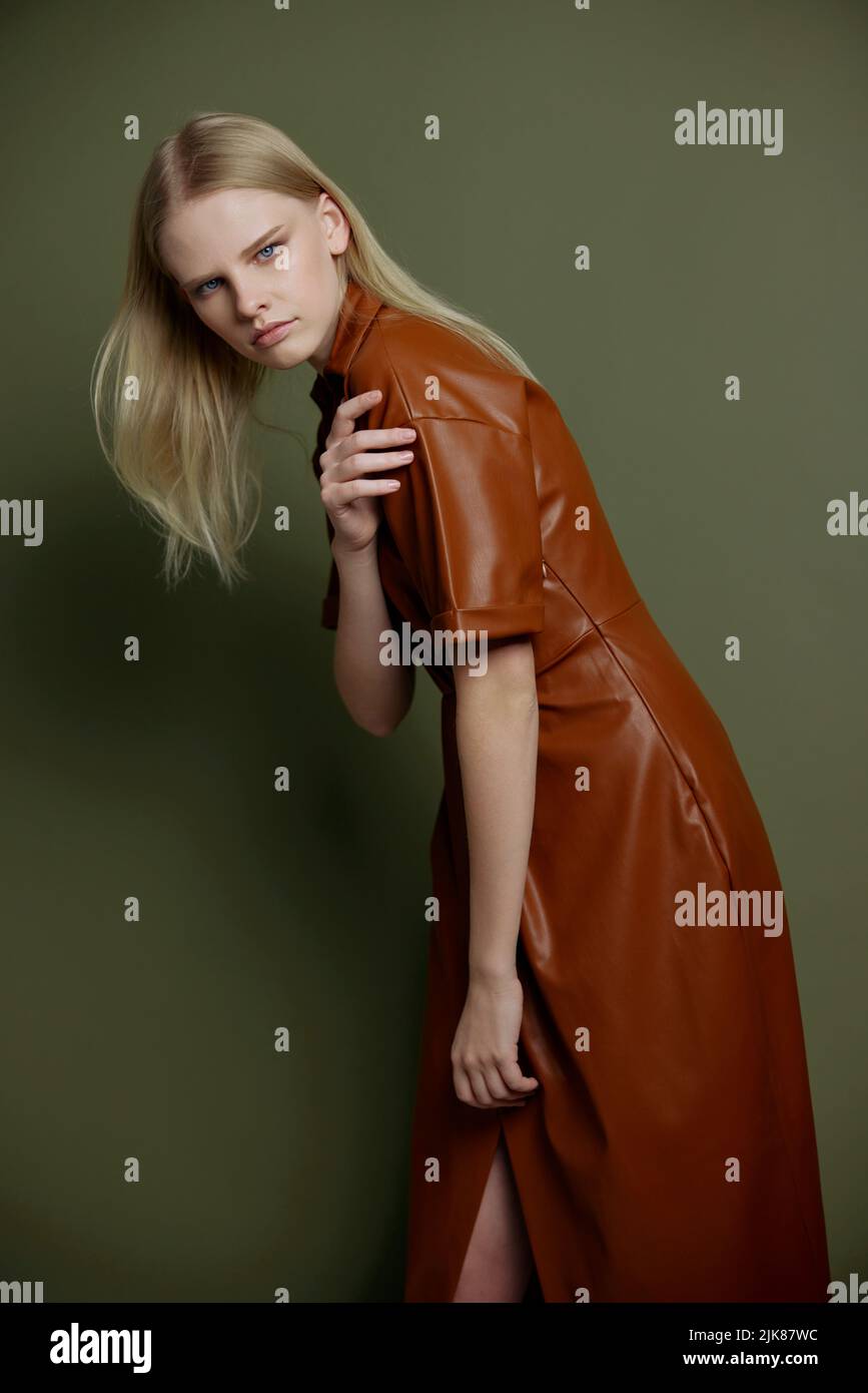 Stylish young blonde model with blue eyes and evening makeup posing in ...