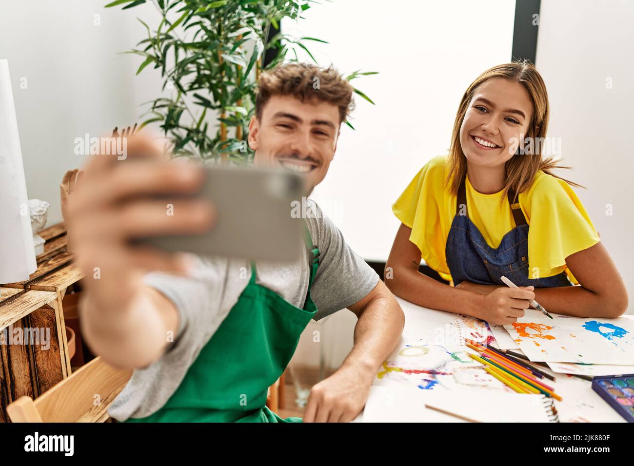 Young hispanic artist couple smiling happy making selfie by the ...