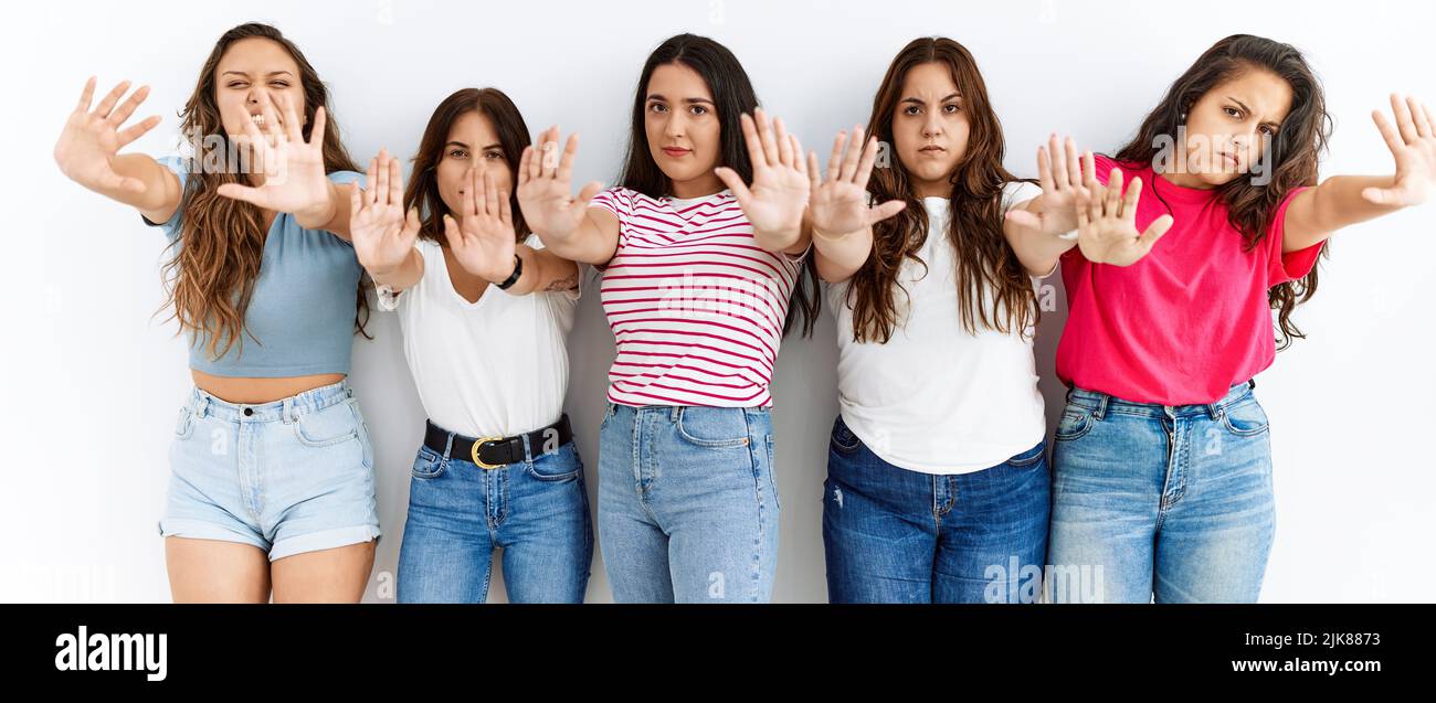 Group of women wearing casual clothes standing over isolated background ...