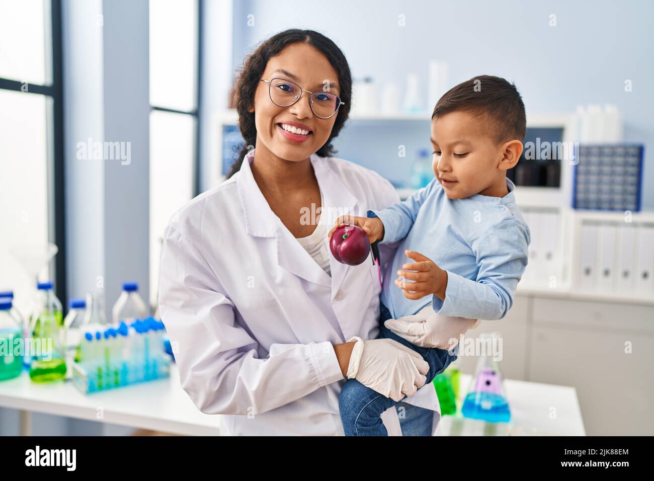 Mother and son wearing scientist uniform hugging each other at ...