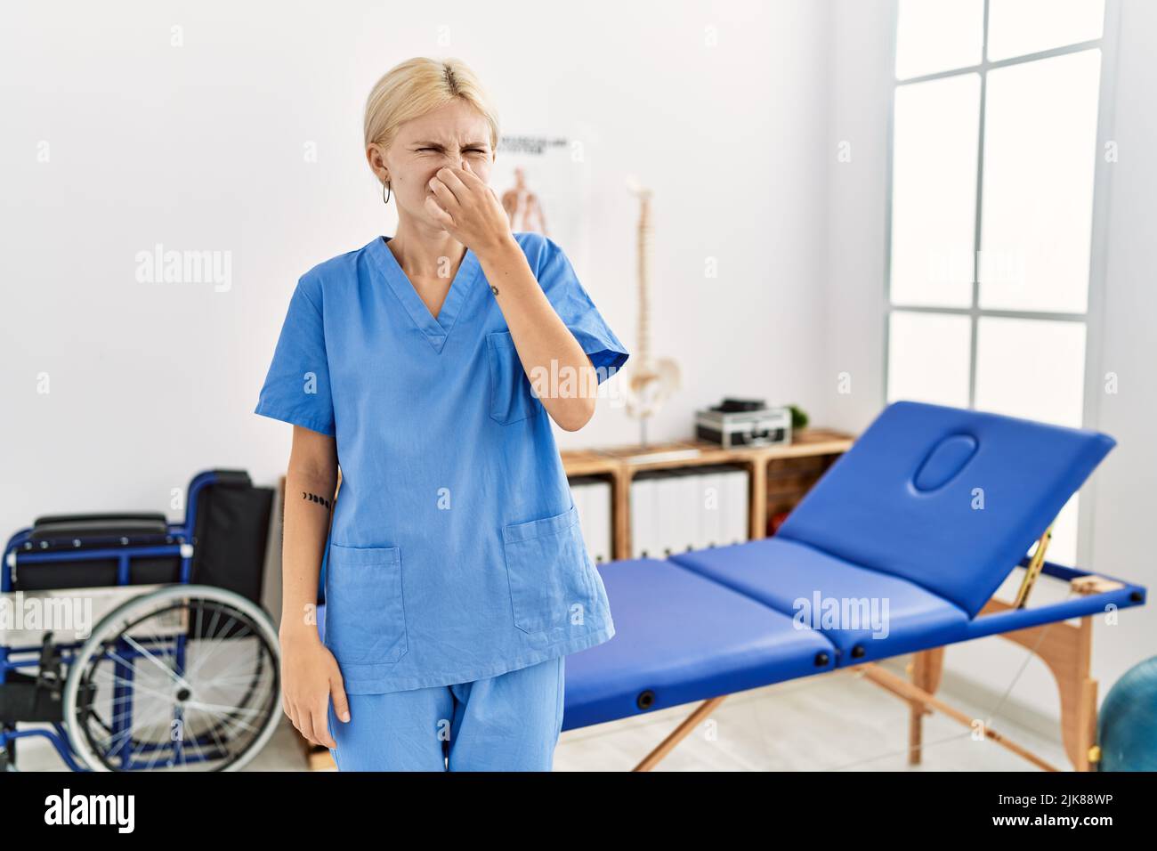 Beautiful caucasian physiotherapist woman working at pain recovery ...