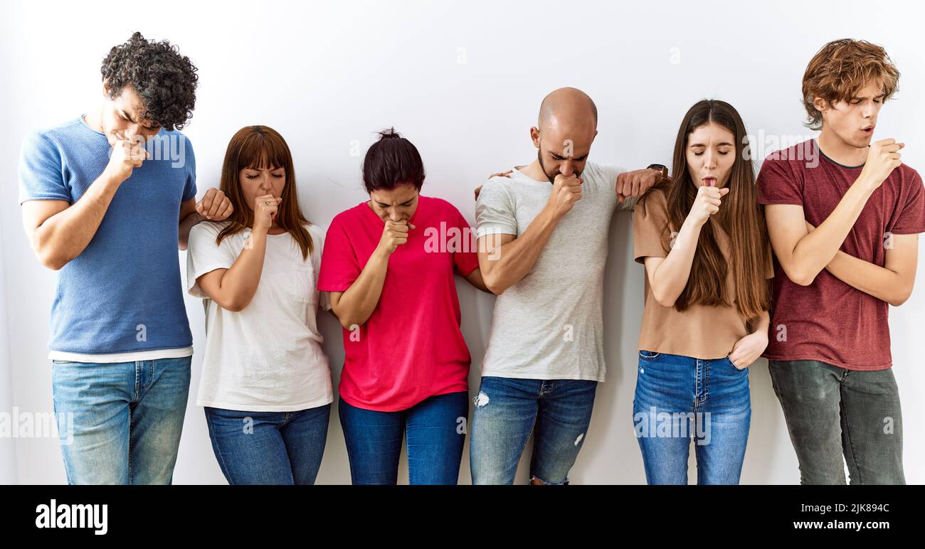 Group of young friends standing together over isolated background ...