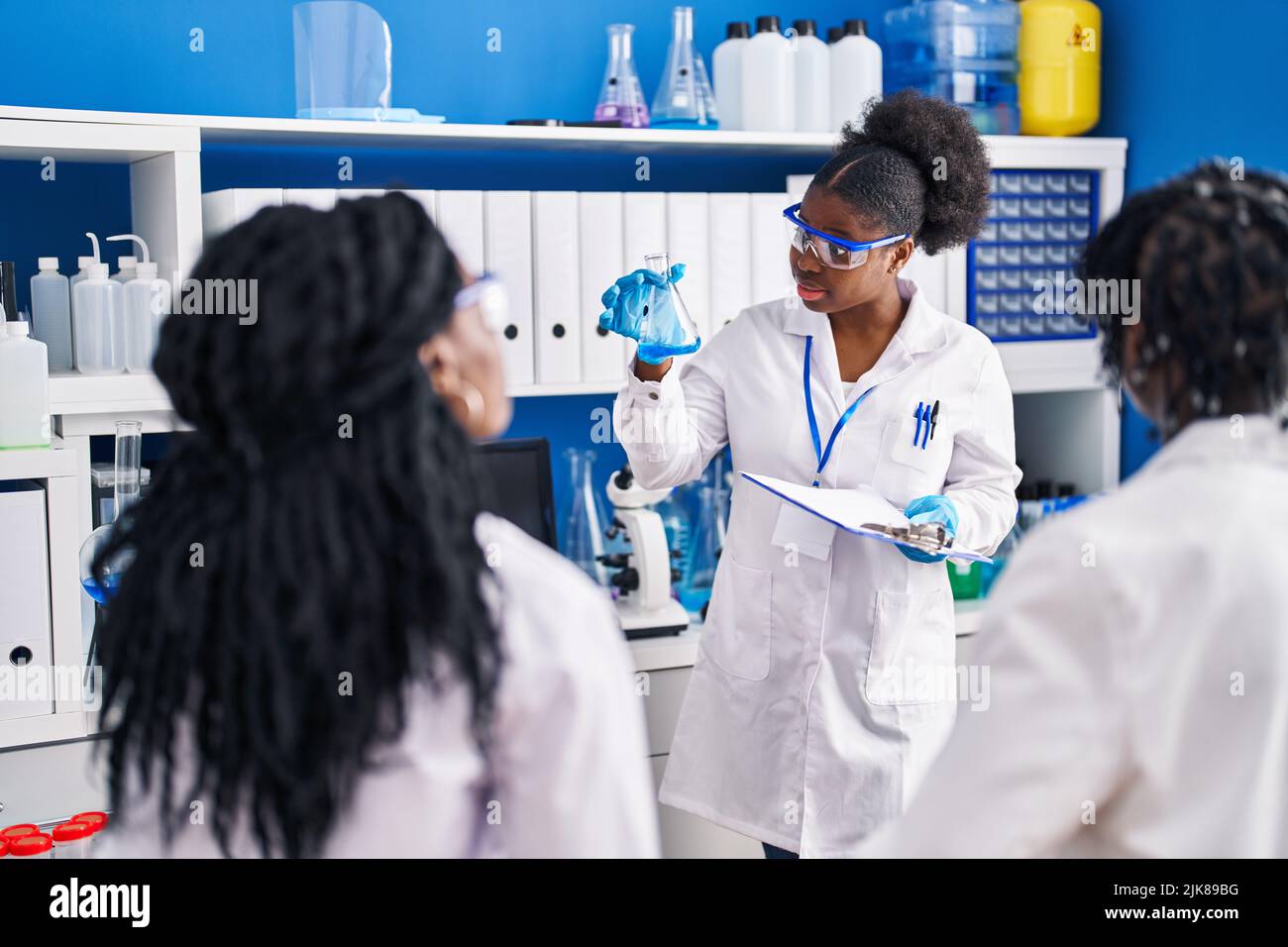 African american friends scientists explaining experiment at laboratory ...