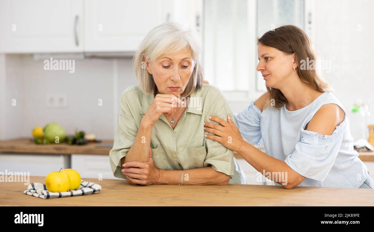 Mature mother comforting sad daughter hi-res stock photography and images - Alamy