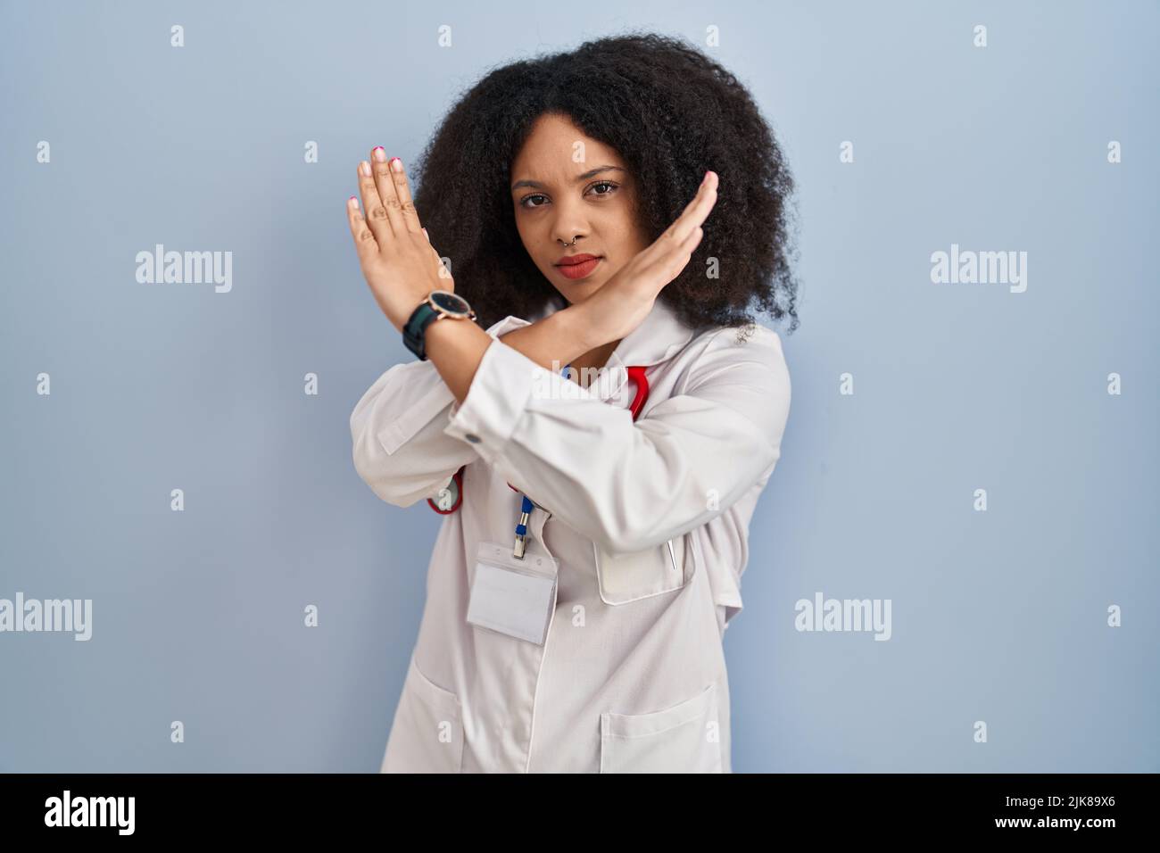 Young african american woman wearing doctor uniform and stethoscope ...