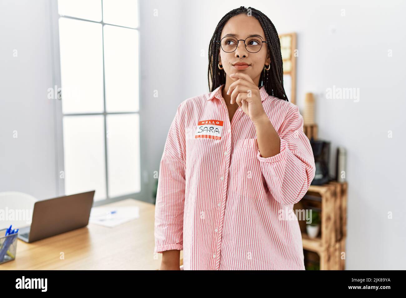 Young african american woman wearing hello my name is sticker ...