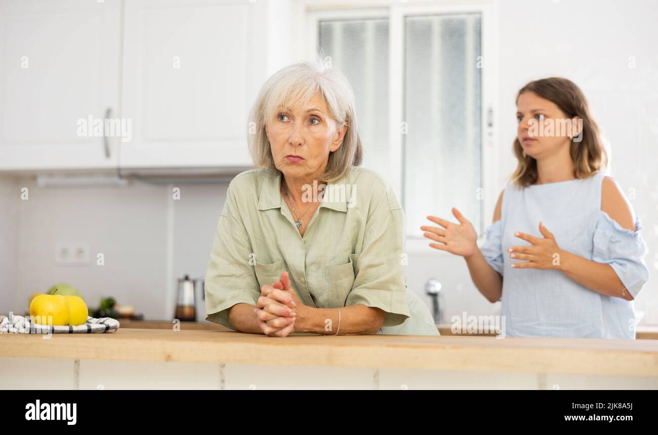 Sad senior woman ignoring her daughter arguing with her Stock Photo - Alamy