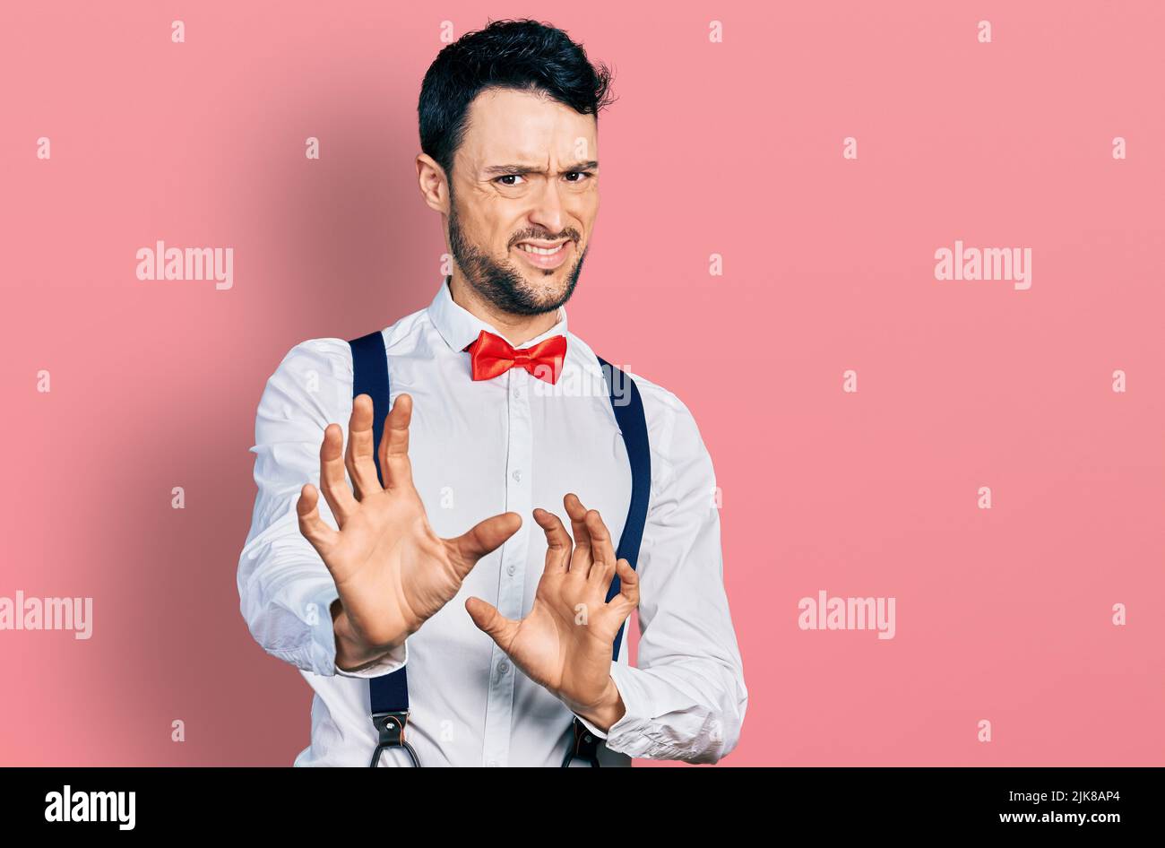 Hispanic man with beard wearing hipster look with bow tie and ...
