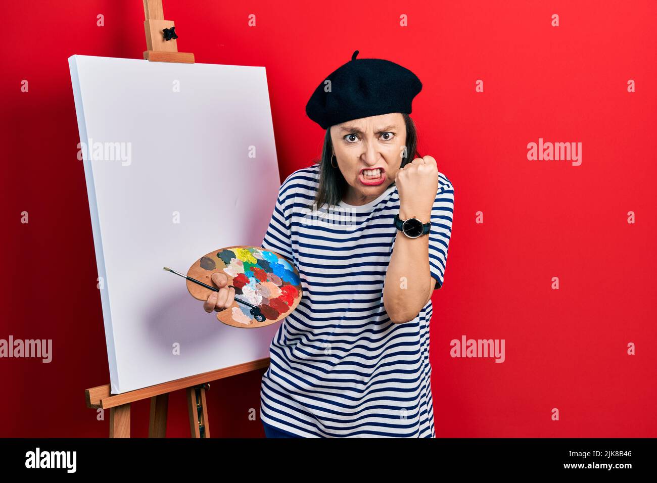 Middle age hispanic woman standing drawing with palette by painter ...