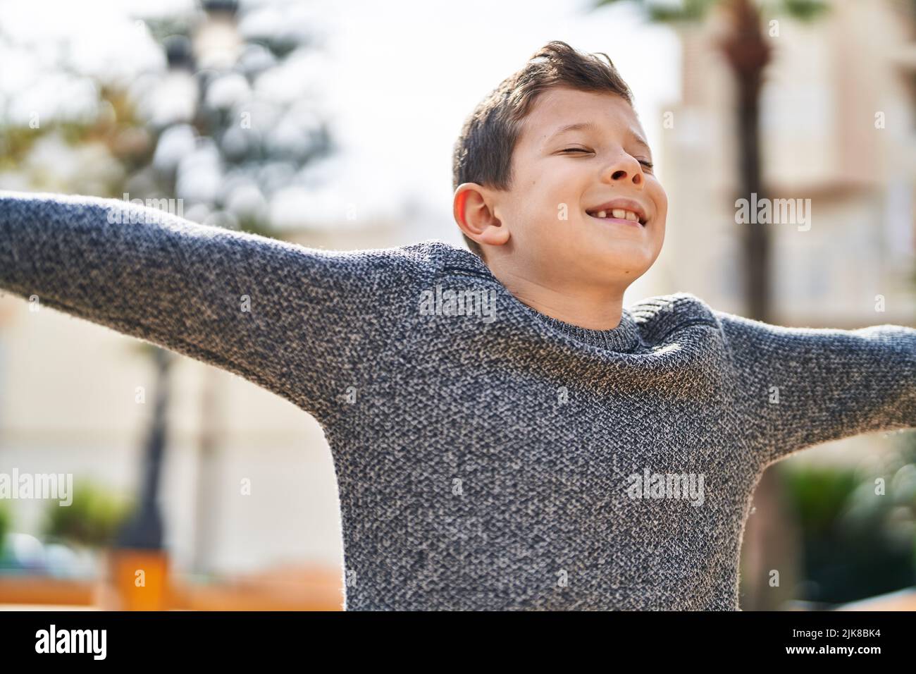 Blond child smiling confident breathing at park Stock Photo - Alamy