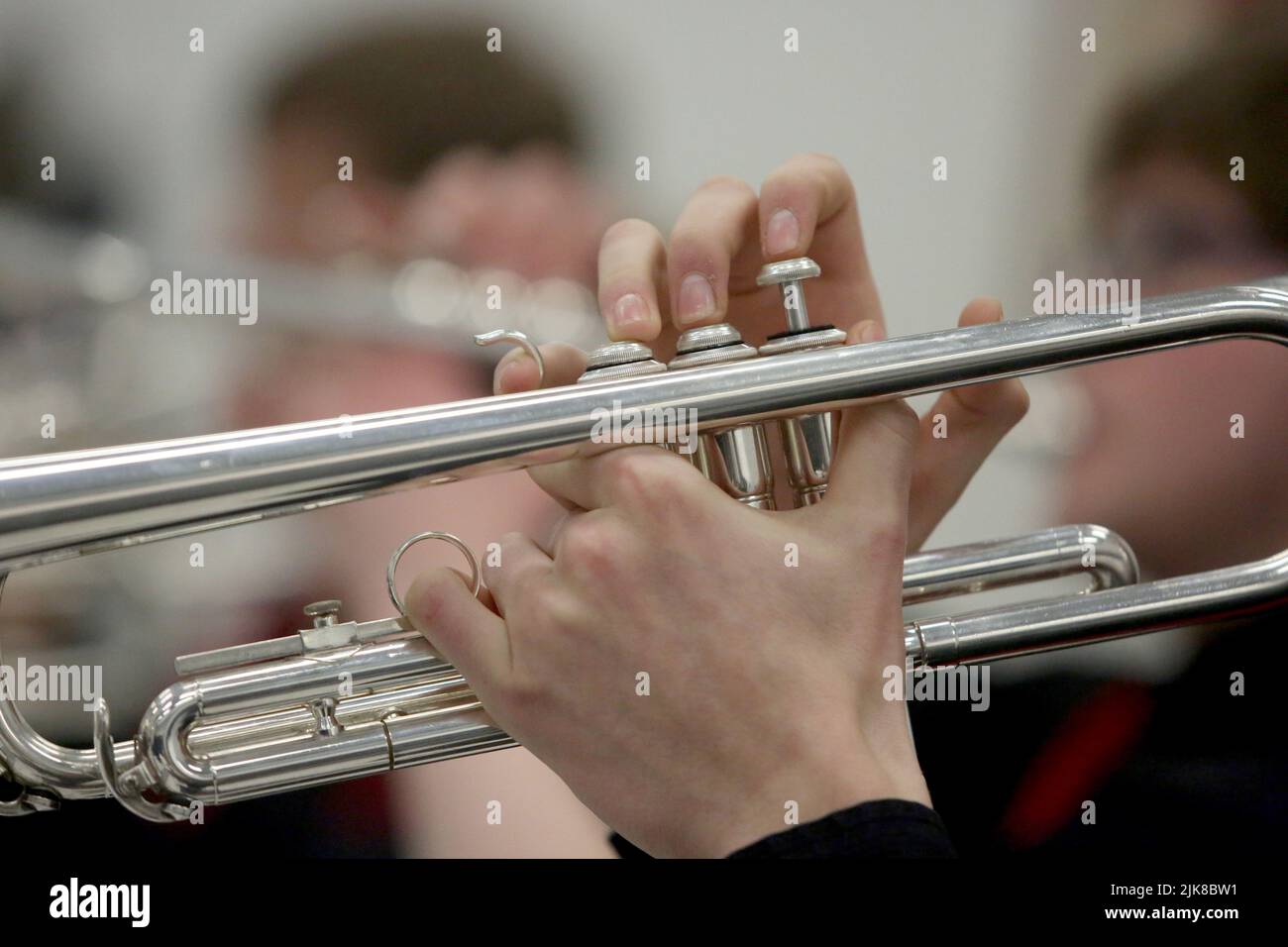 A closeup of the hands of a musician playing a trumpet Stock Photo - Alamy