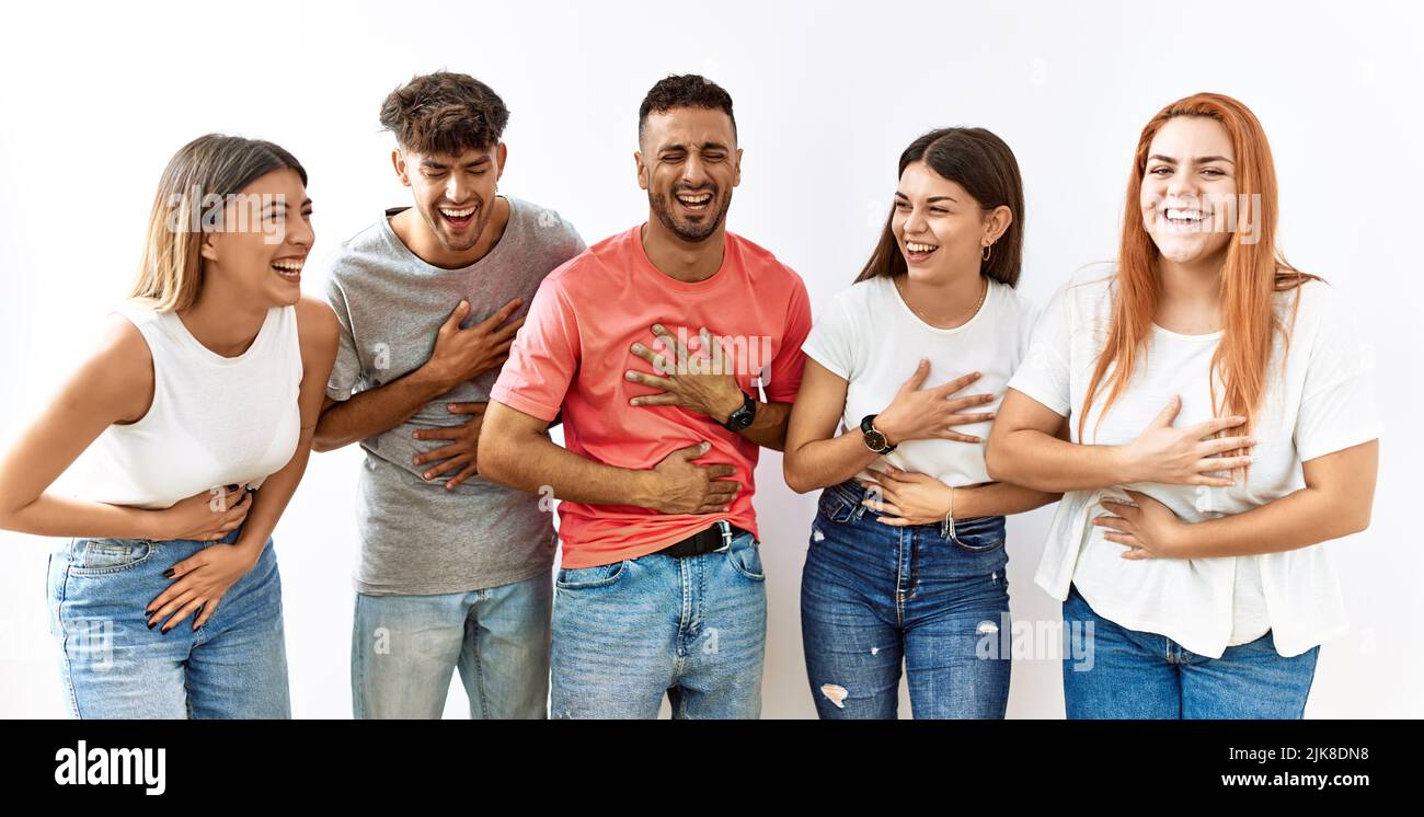 Group of young friends standing together over isolated background ...