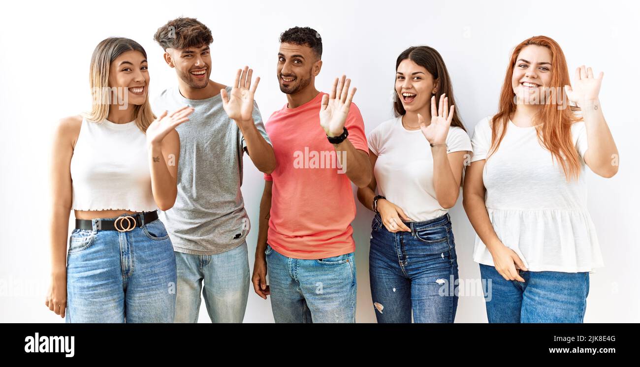 Group of young friends standing together over isolated background ...